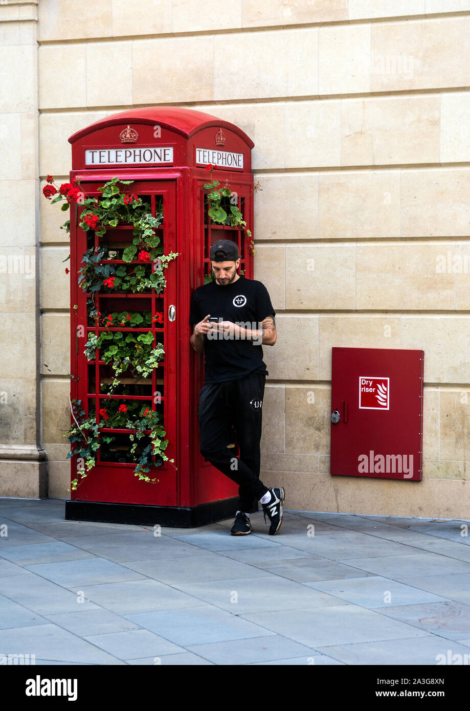 Old GPO Telephone Box with Flowers Stock Photo - Alamy