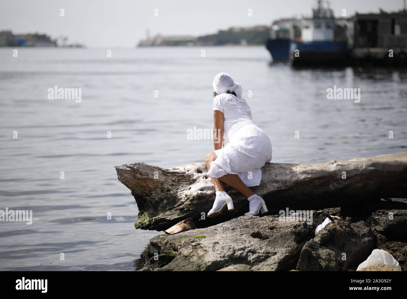 People dressed in white pay tribute to Yemaya, a deity of the Afro ...