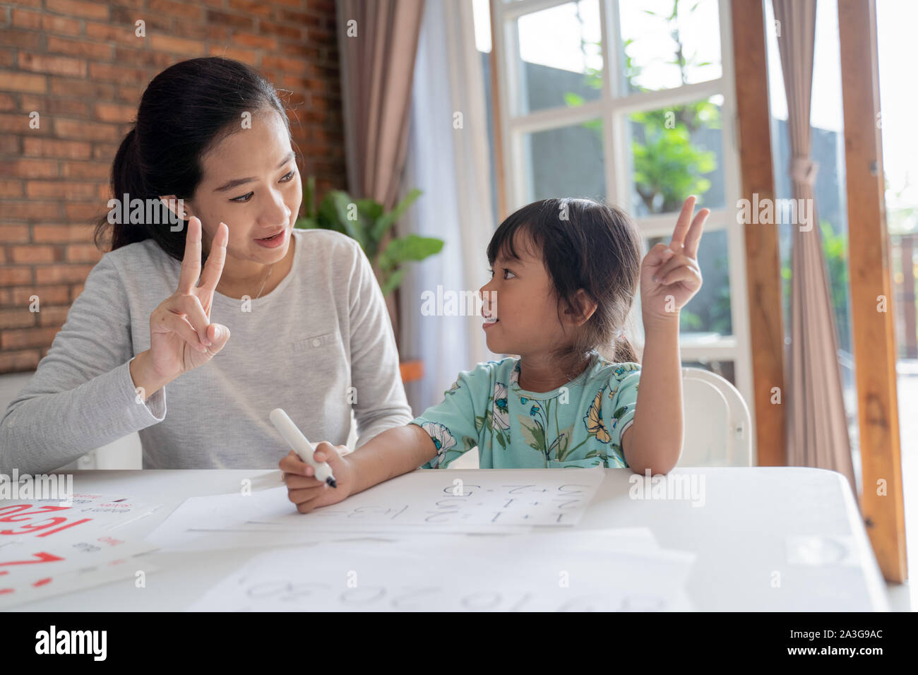 happy mum and kid learning maths together at home Stock Photo - Alamy