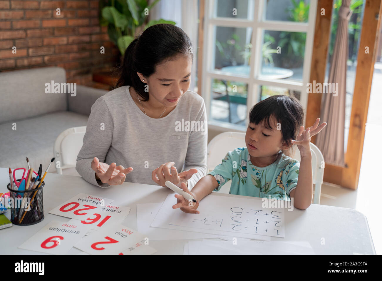 happy mum and kid learning maths together at home Stock Photo - Alamy