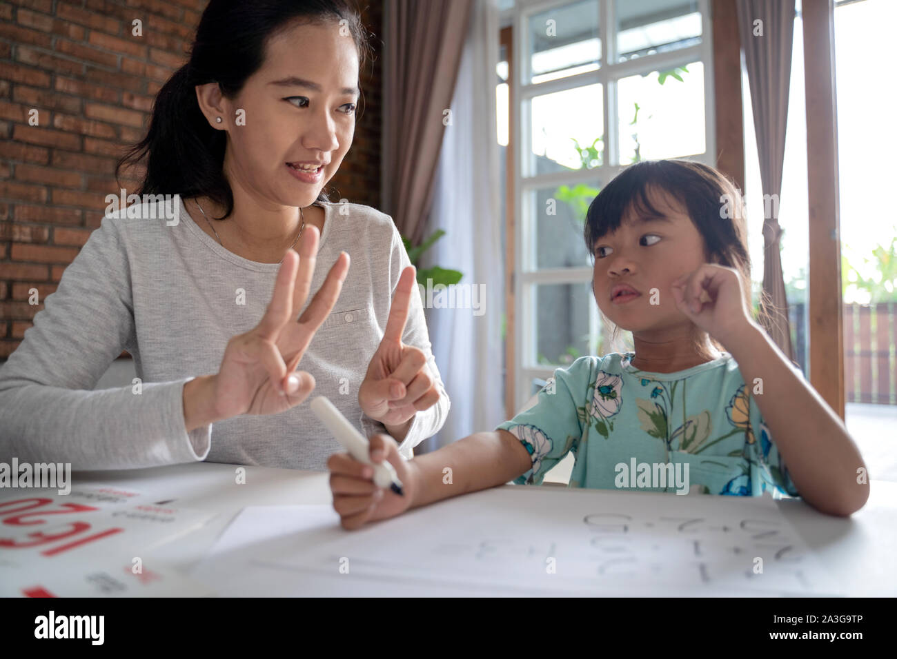 happy mum and kid learning maths together at home Stock Photo - Alamy