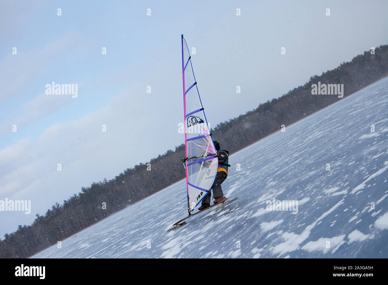 Man ice sailing on windsurfer on frozen lake in winter Stock Photo - Alamy