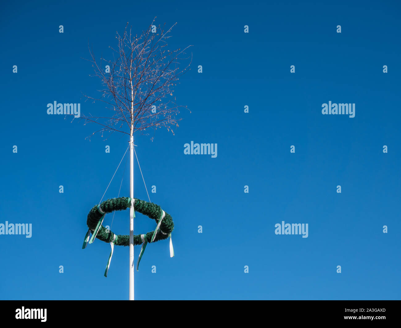 Maypole on blue background Stock Photo - Alamy