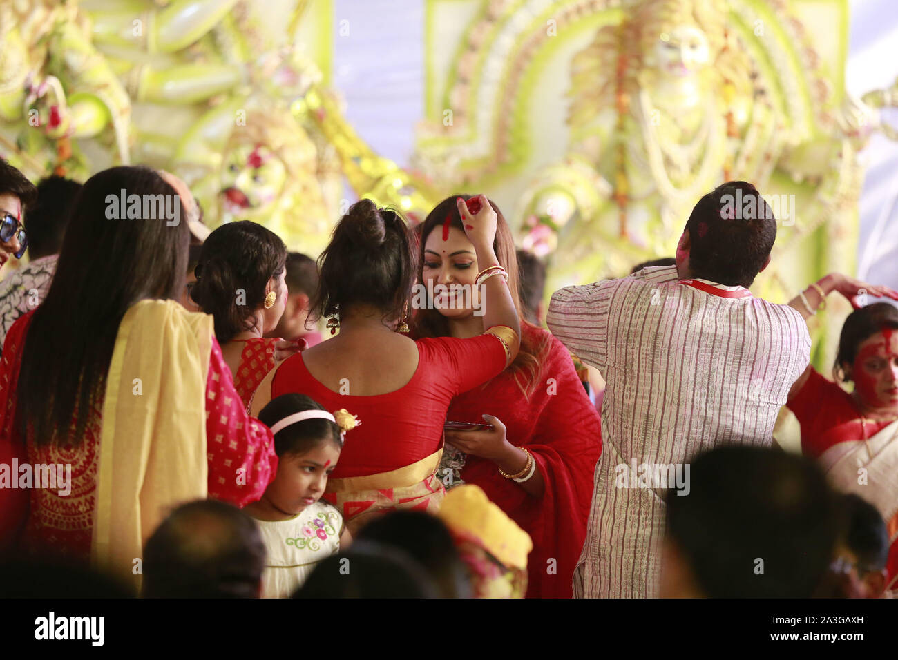 Dhaka, Bangladesh. 8th Oct, 2019. Hindu devotees smear vermillion on each other during Sindoor ...