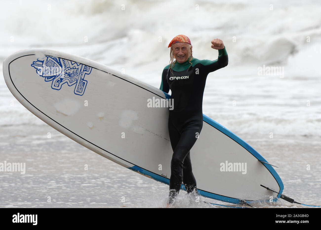 Surfer poses with long board after a hard day's surf Stock Photo - Alamy