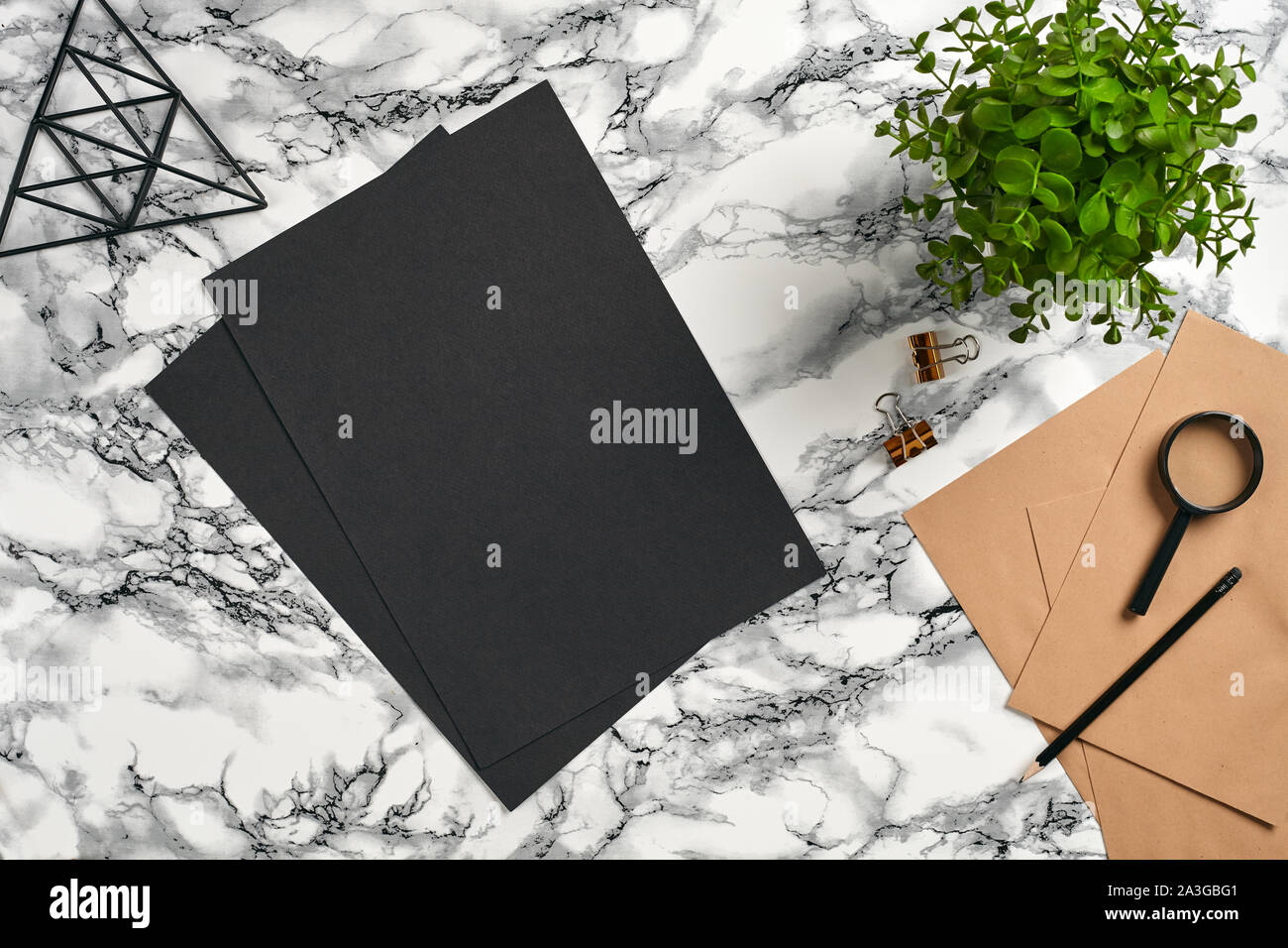 Black and brown sheets of paper, pencil, golden paper clips, iron ...