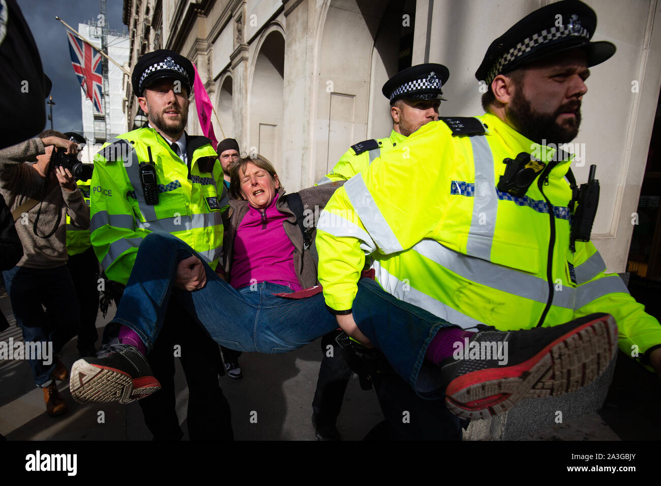 Police remove a demonstrator during an Extinction Rebellion (XR ...