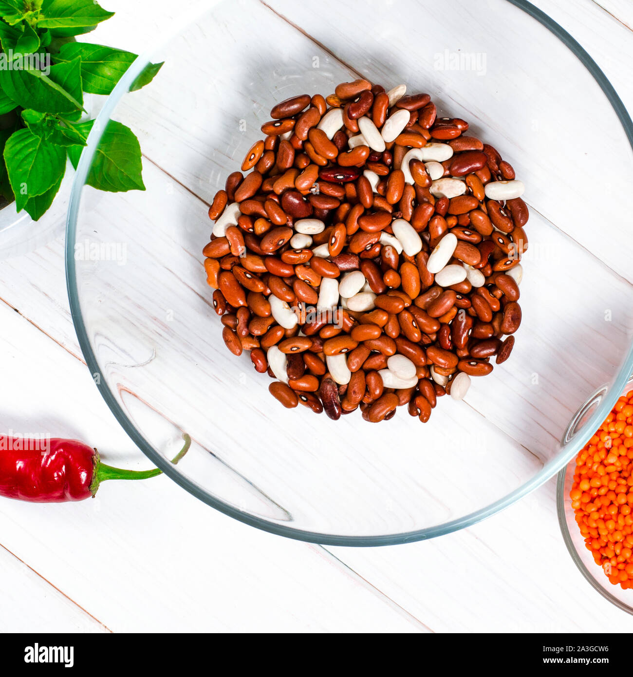 The bean diet. Beans, lentils, sesame garlic and basil in glass plates ...