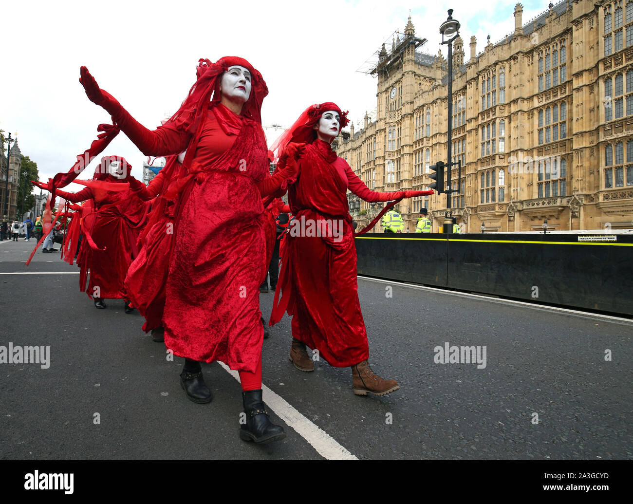 Protesters dubbed the Red Rebels walk past Parliament, during an ...