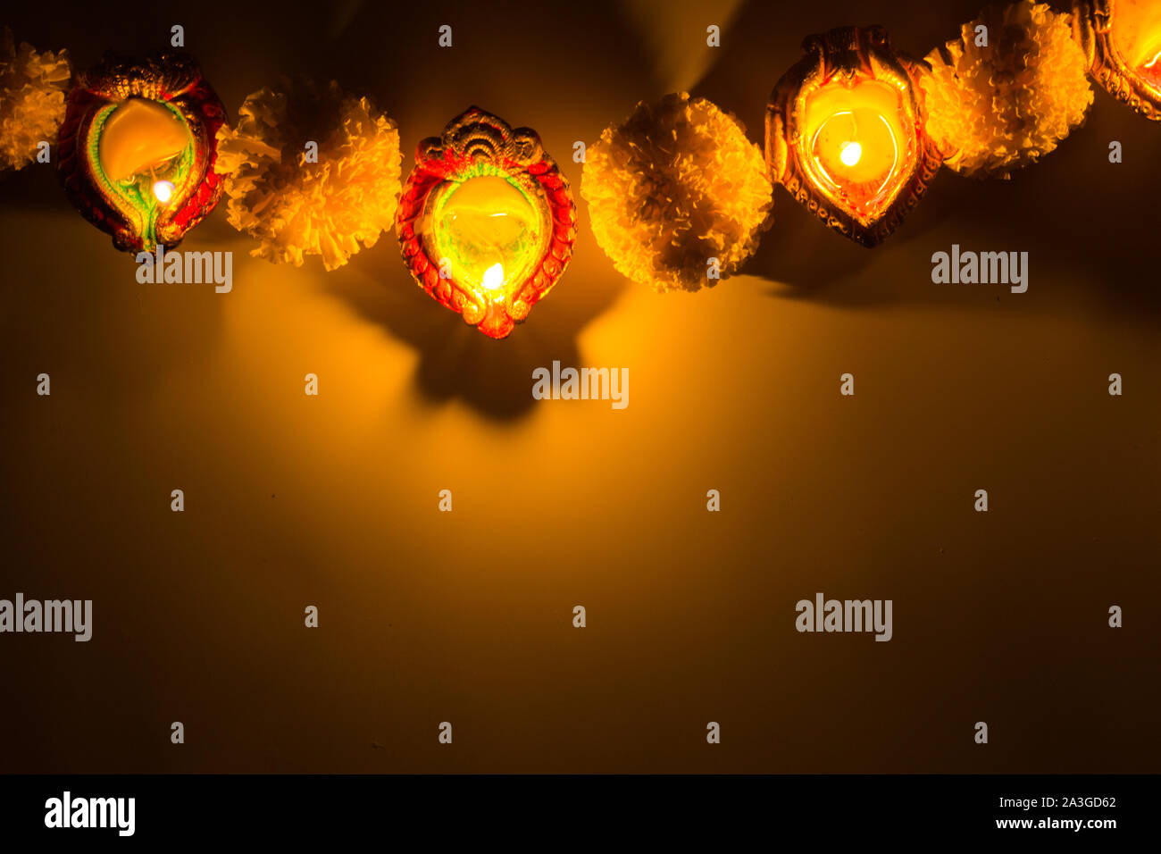 Indian festival Diwali, Diya oil lamps lit on colorful rangoli. Hindu ...