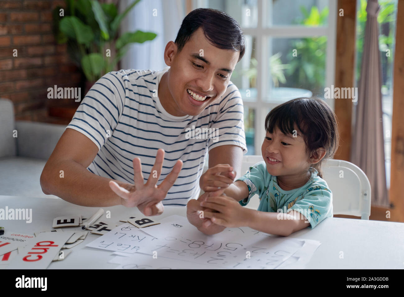 toddler learning math and counting with her father at home together ...