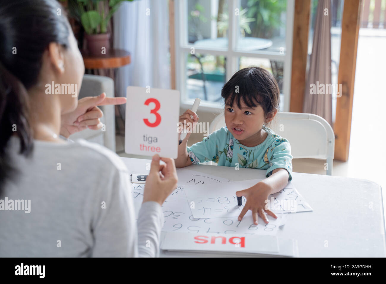 happy kid learning and studying together with parent at home ...