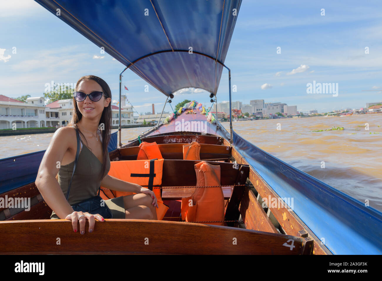 Tourist woman exploring the city of Bangkok with river boat Stock Photo ...