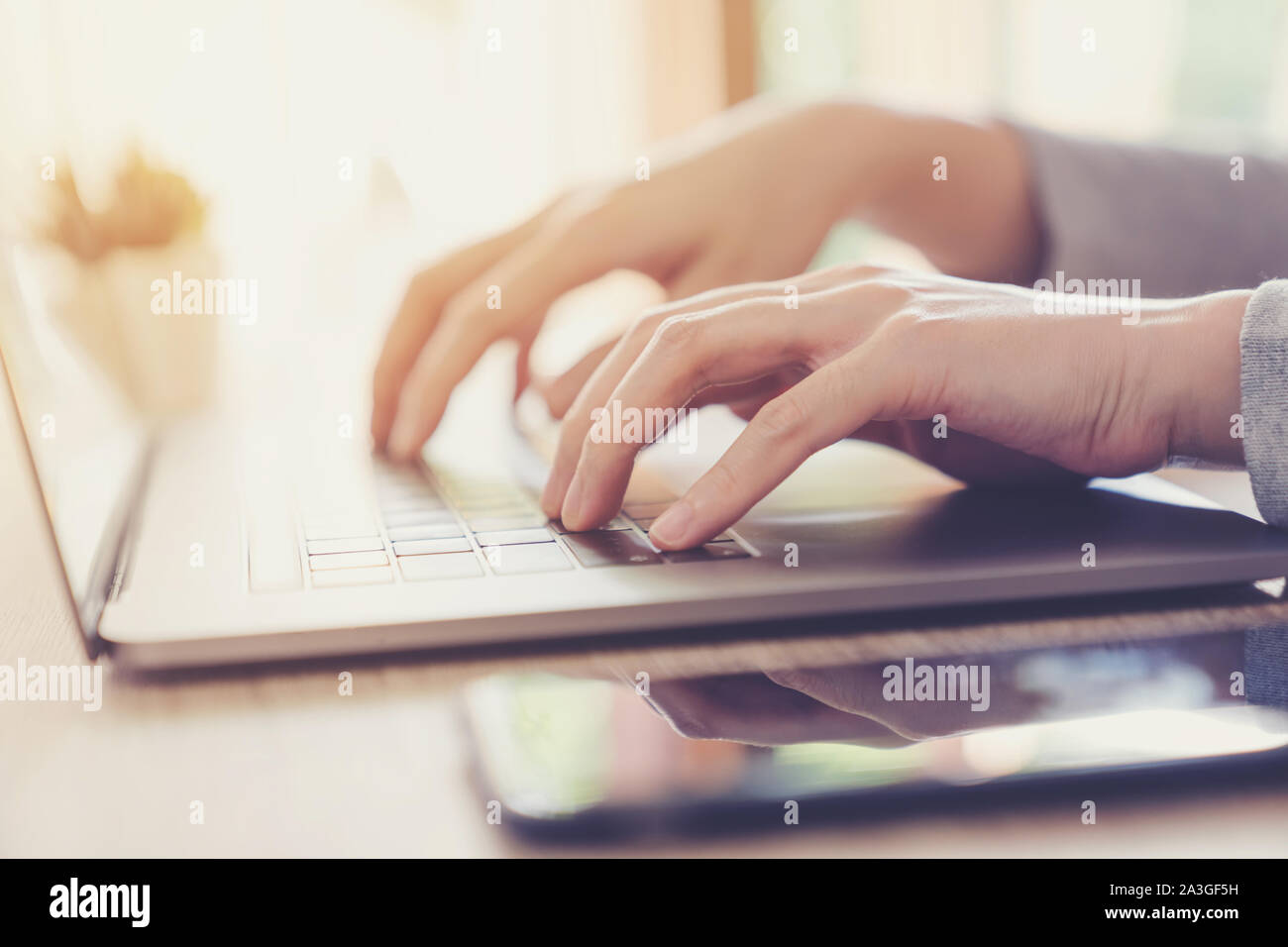 Business woman hand typing laptop computer on wooden table Stock Photo ...