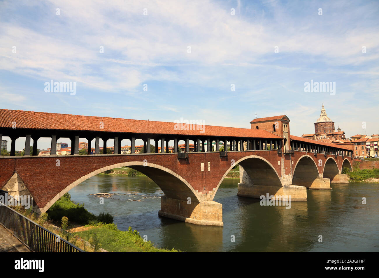 view of Ticino River and the very old Covered Bridge in Pavia Town in ...