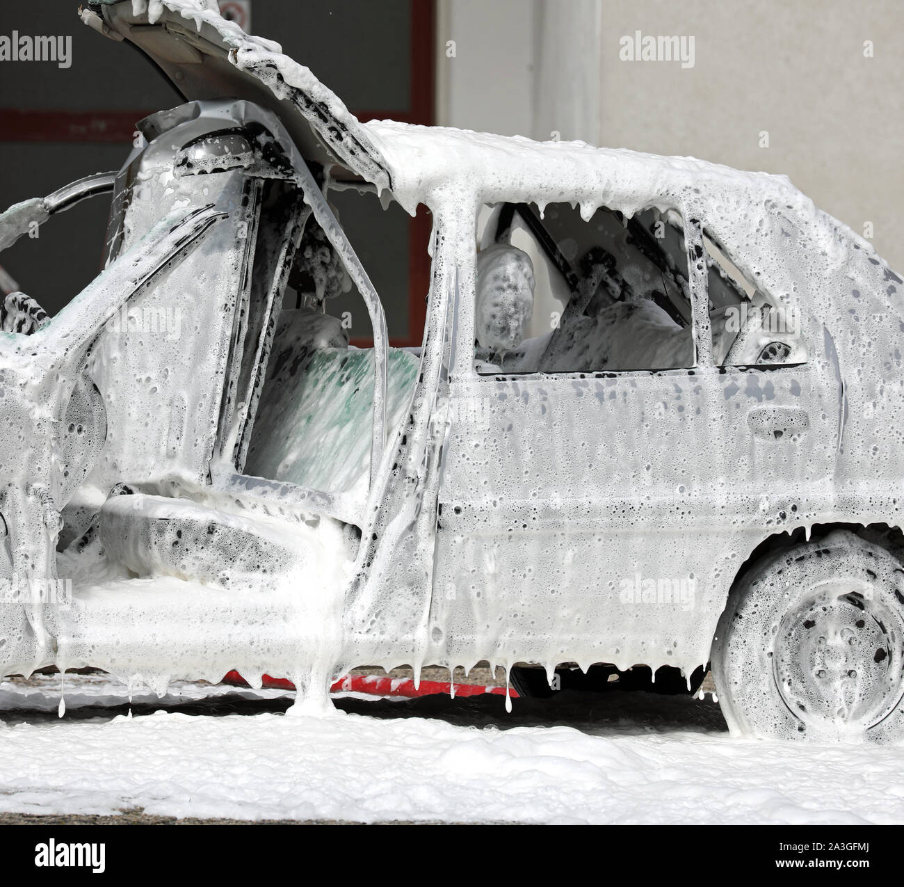 accident-damaged car covered with foam used by firefighters to ...