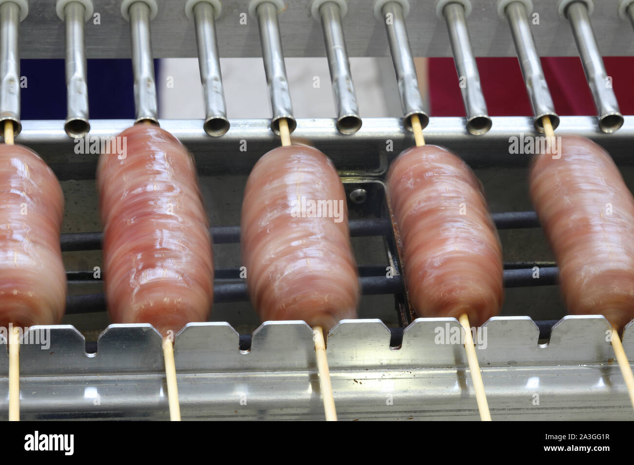 rotating spit with many sausage of pork at festival Stock Photo - Alamy