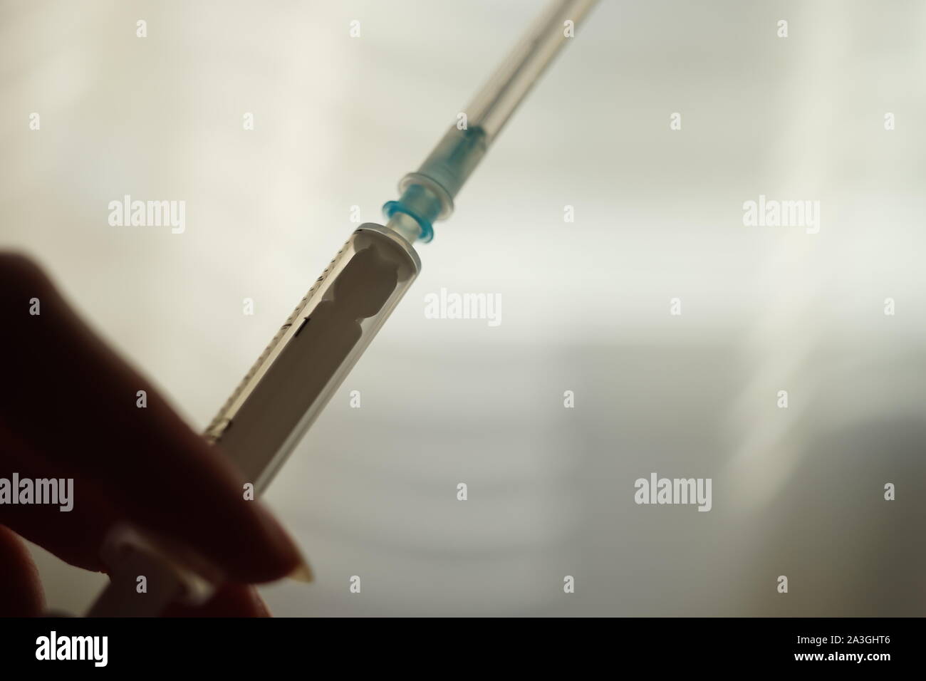 syringe in female hand, side view with selective focus Stock Photo - Alamy