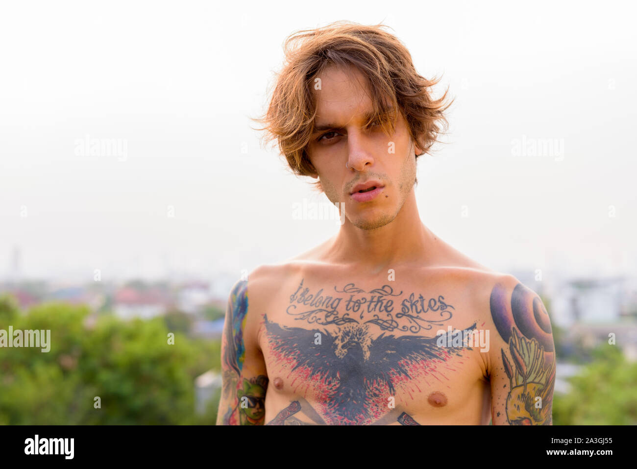 Portrait of young handsome rebellious man shirtless outdoors Stock ...