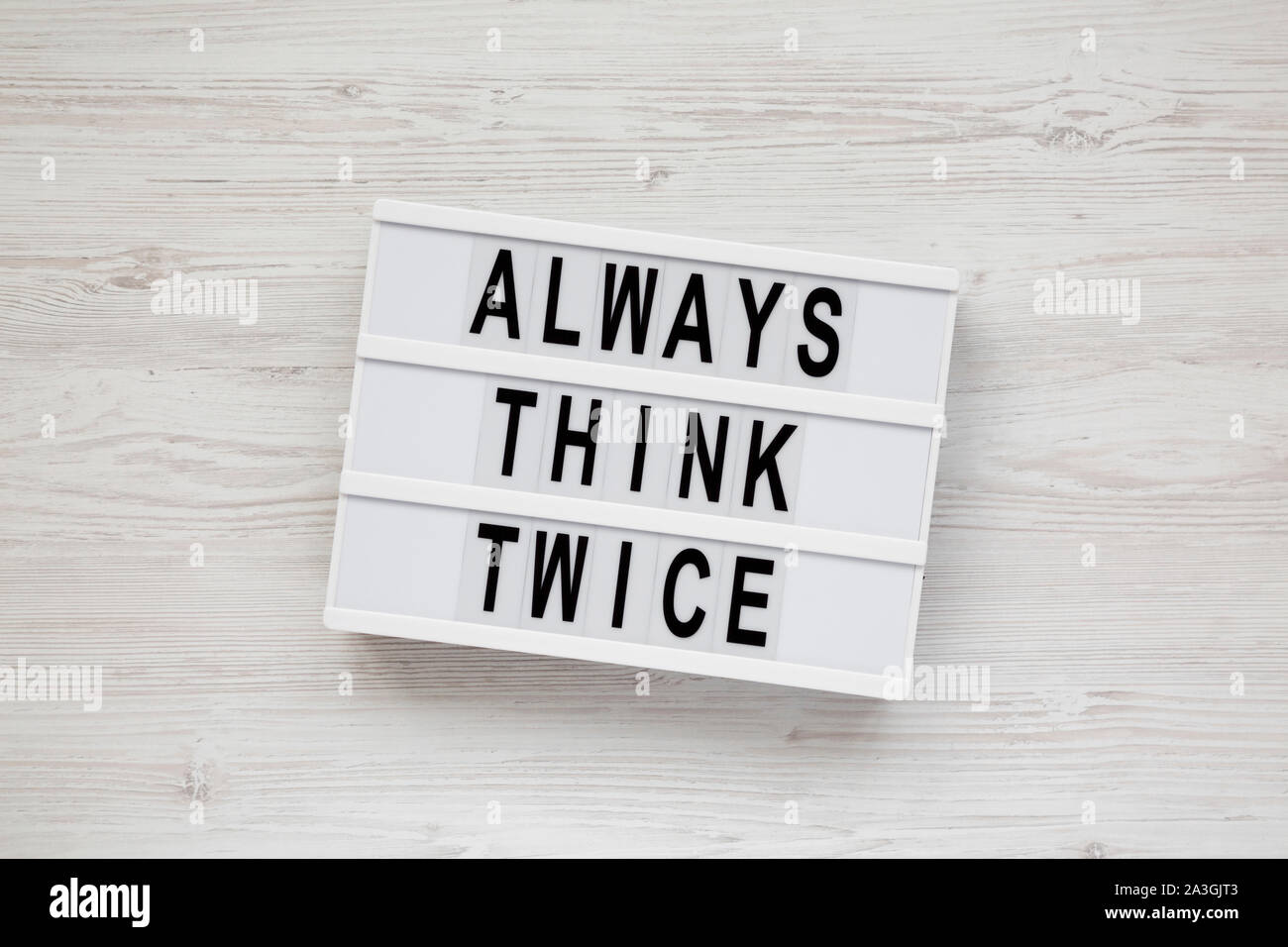 'Always think twice' words on a modern board over white wooden surface ...