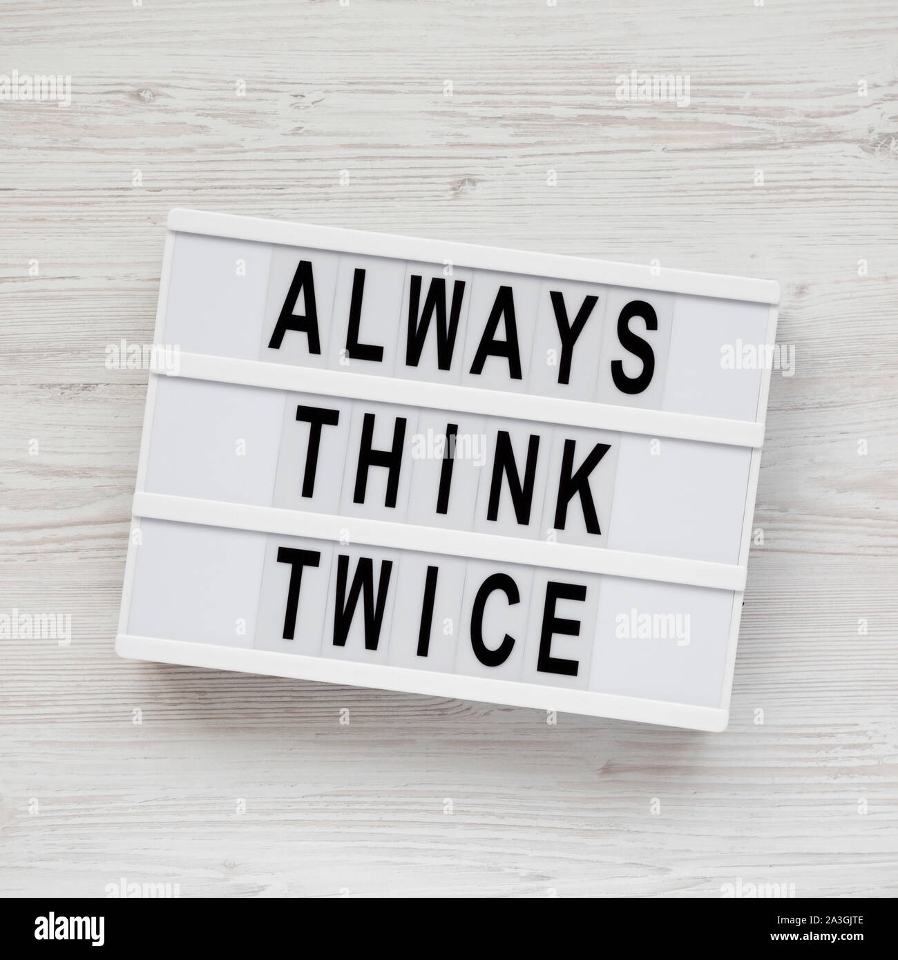 'Always think twice' words on a modern board over white wooden surface ...
