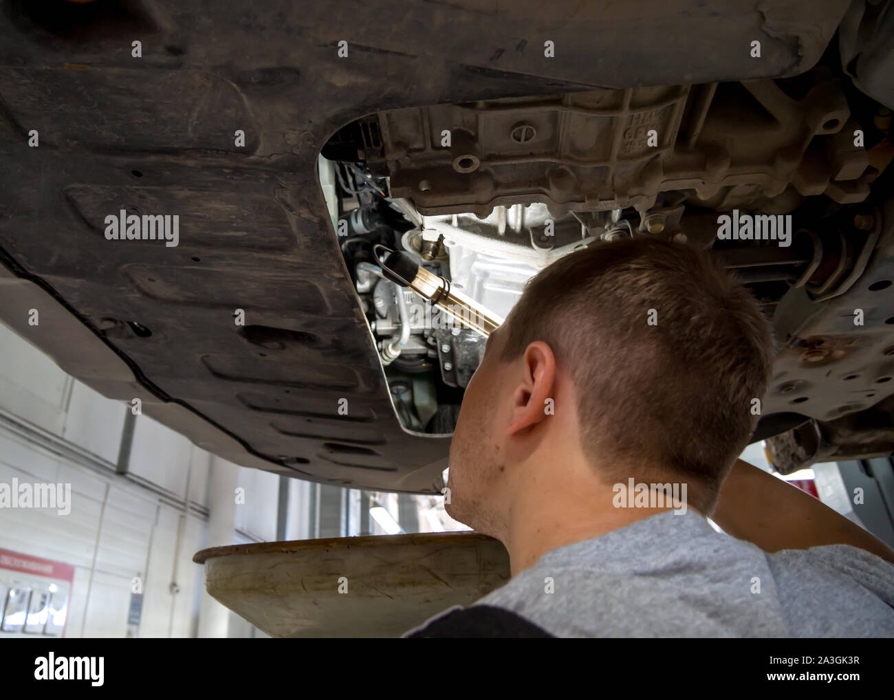 Voronezh, Russia - May 30, 2019: Auto mechanic inspects the bottom of a ...