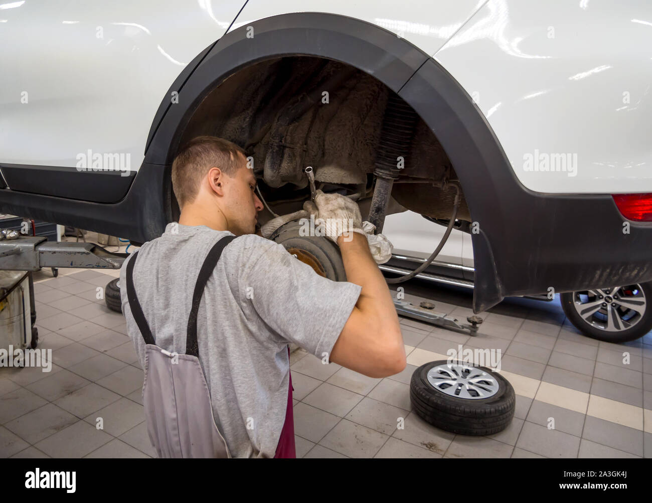 Voronezh, Russia - May 30, 2019: Auto mechanic servicing a car brake ...