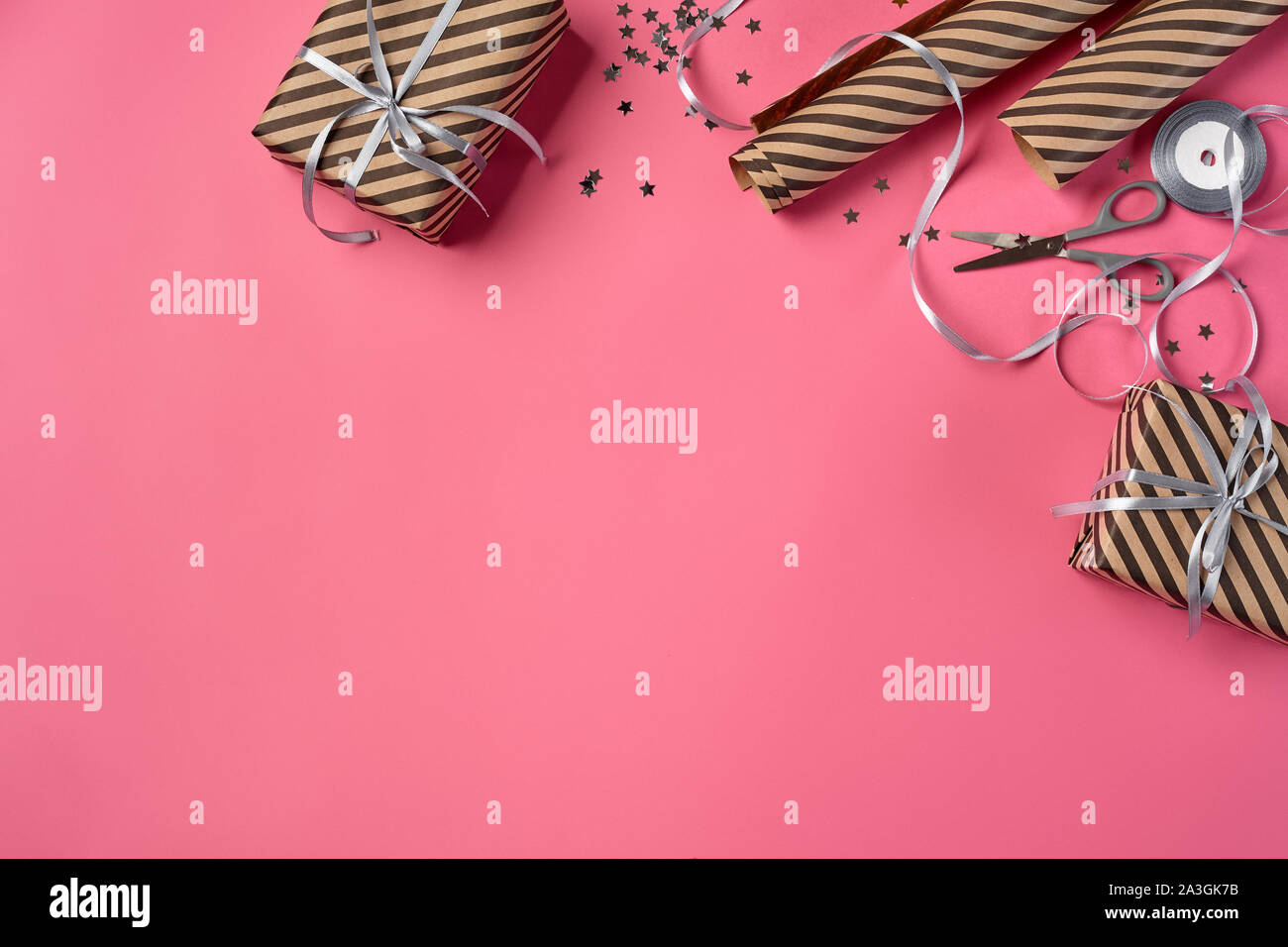 Different sizes, striped, brown gift boxes tied with black and silver ...