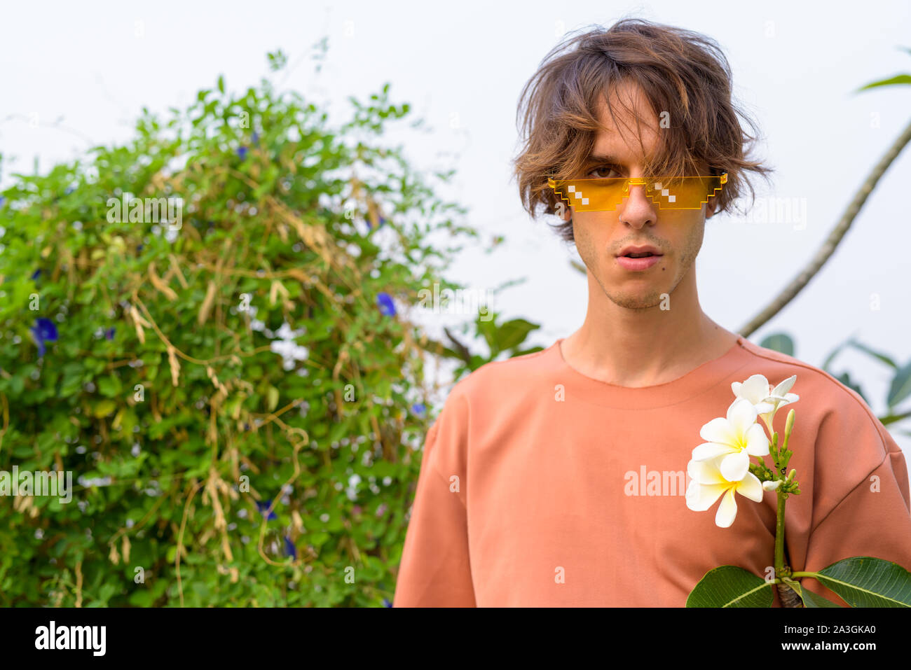Young handsome rebellious man outdoors wearing glasses Stock Photo - Alamy