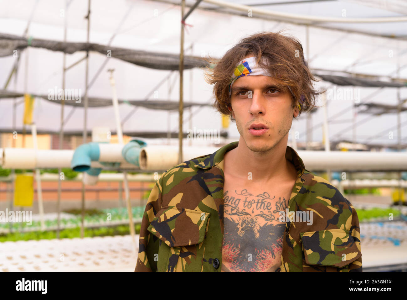 Portrait of young handsome rebellious man outdoors Stock Photo - Alamy