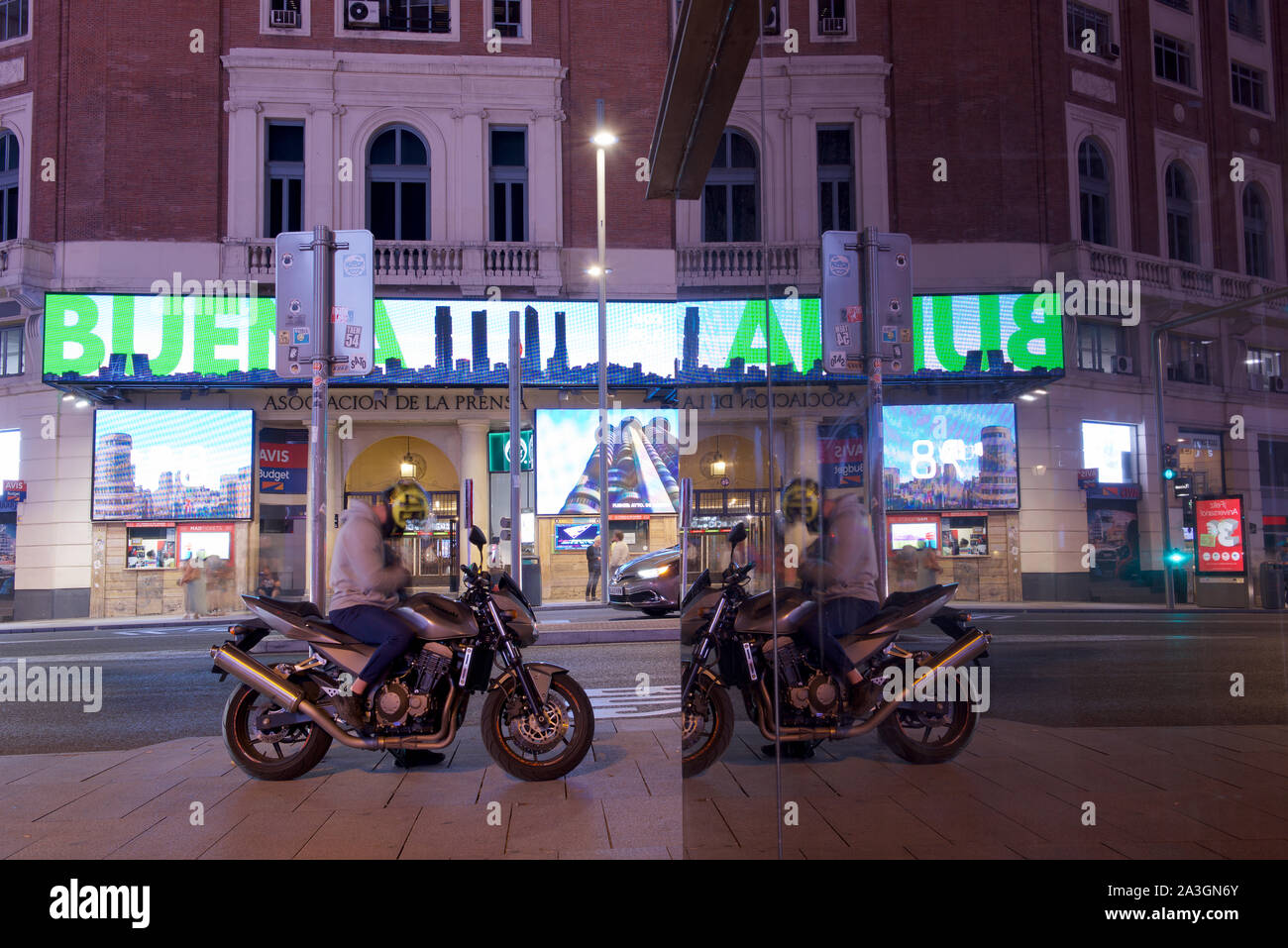 Motorcyclist and reflection at night Stock Photo - Alamy