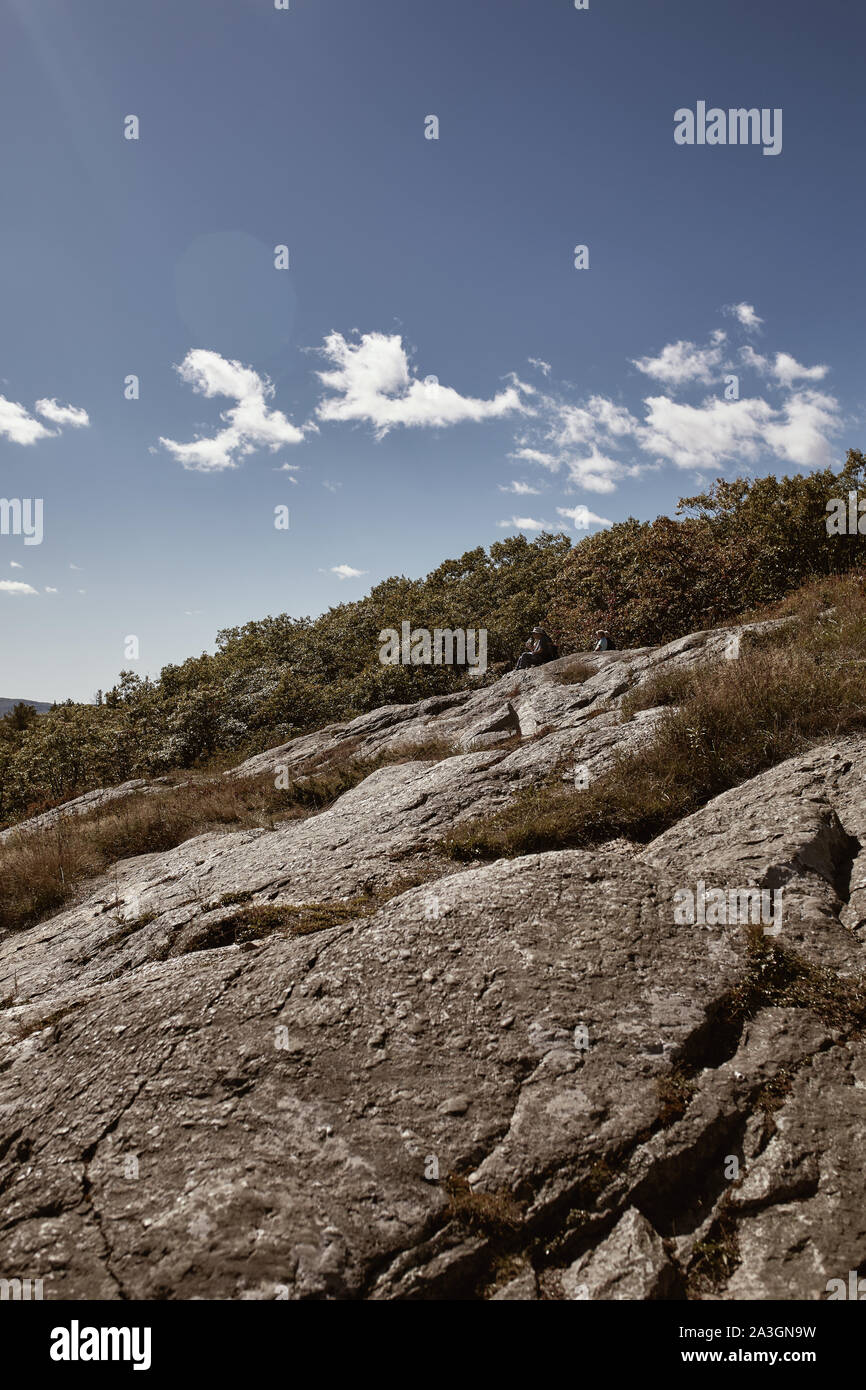 Hiking over bedrock on the summit of Mt Battie at Camden Hills State ...