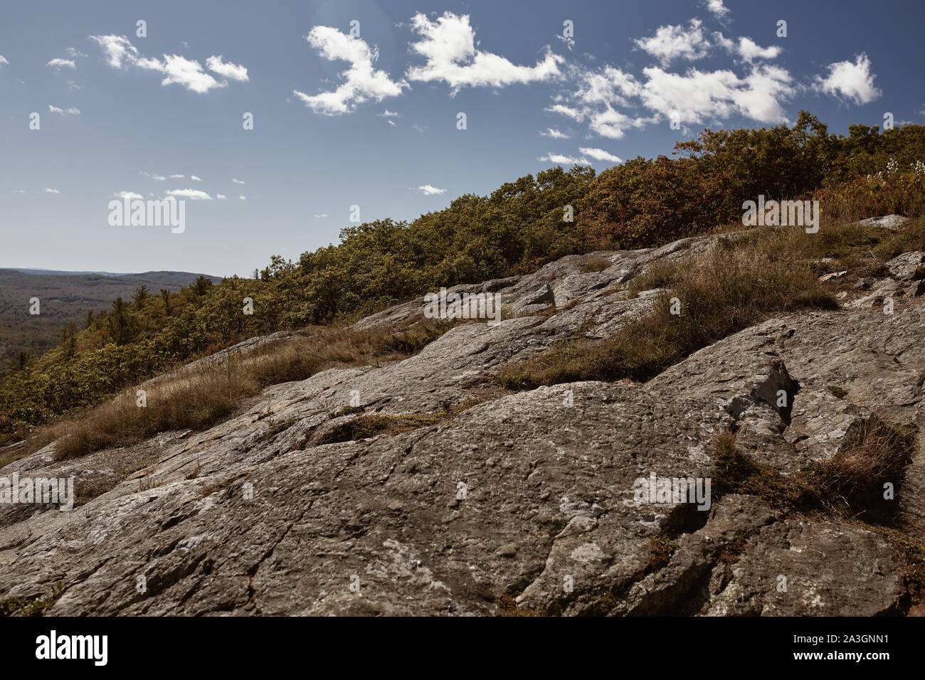 Hiking over bedrock on the summit of Mt Battie at Camden Hills State ...