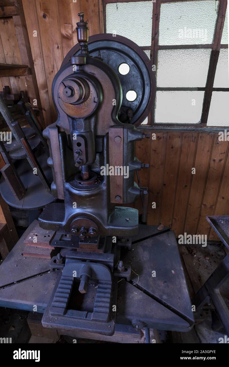 Historical punching machine, tool for metal processing, workshop around ...