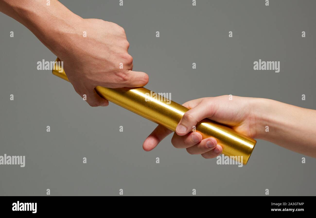 Hands holding baton Stock Photo - Alamy