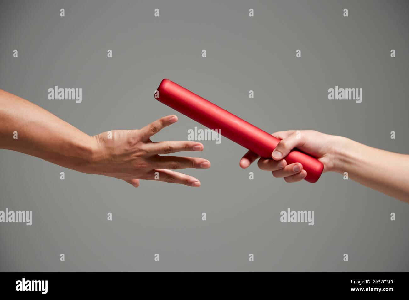 Hands holding baton Stock Photo - Alamy