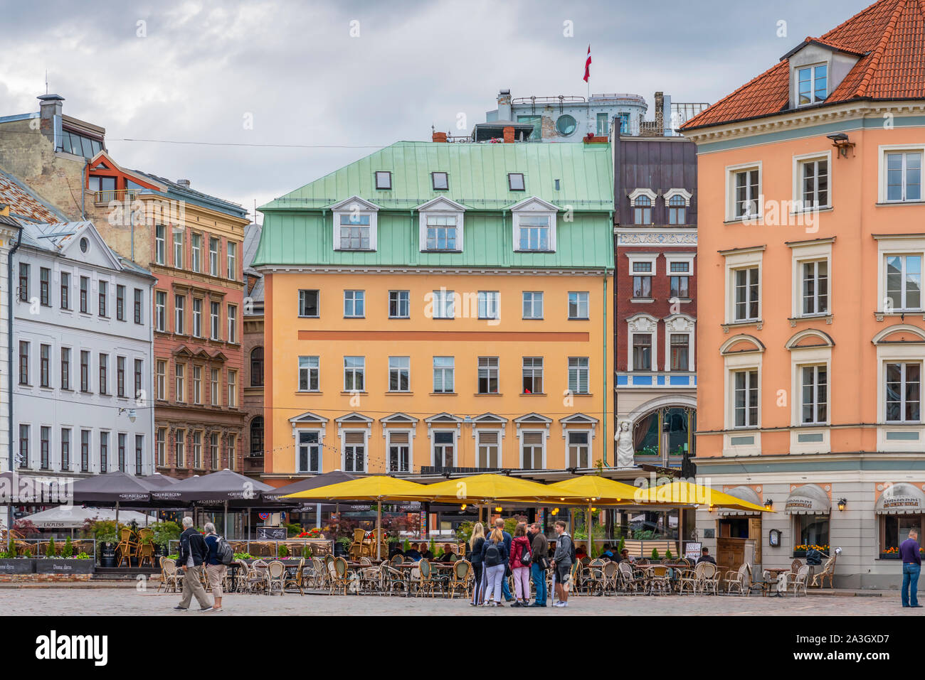 A cobblestoned city square with colourful buildings in Riga, Latvia ...