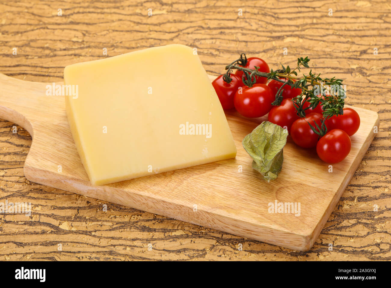 Hard parmesan cheese piece over wooden background Stock Photo - Alamy