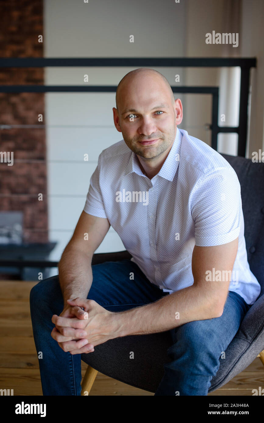 Attractive bald middle aged man sitting hi-res stock photography and ...