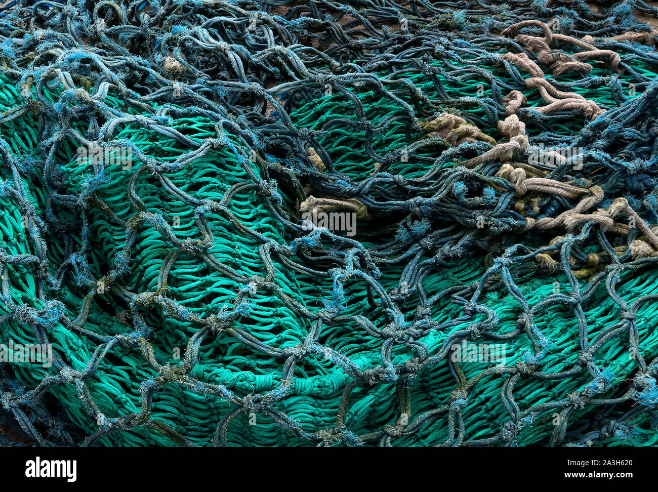 Old fishing nets at a coastal harbour close up view Stock Photo - Alamy