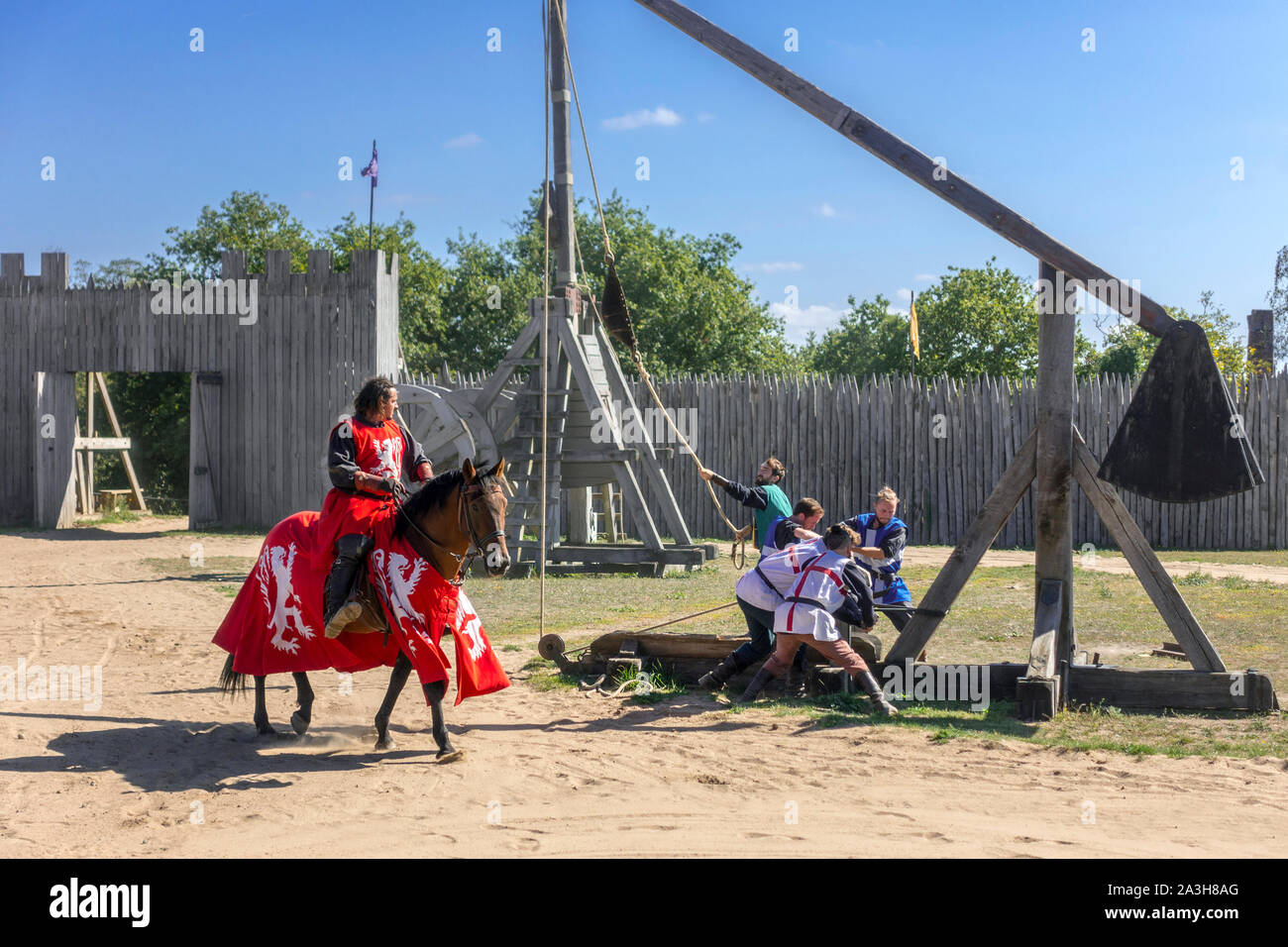 Medieval knight on horseback and couillard, counterweight trebuchet at ...