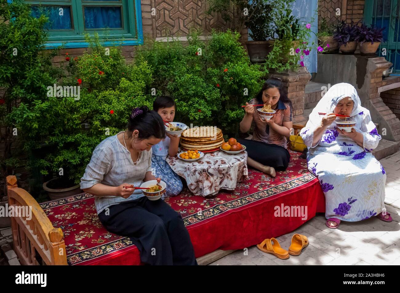 China, Xinjiang autonomous region, Kashgar, Uighur family enjoying a ...