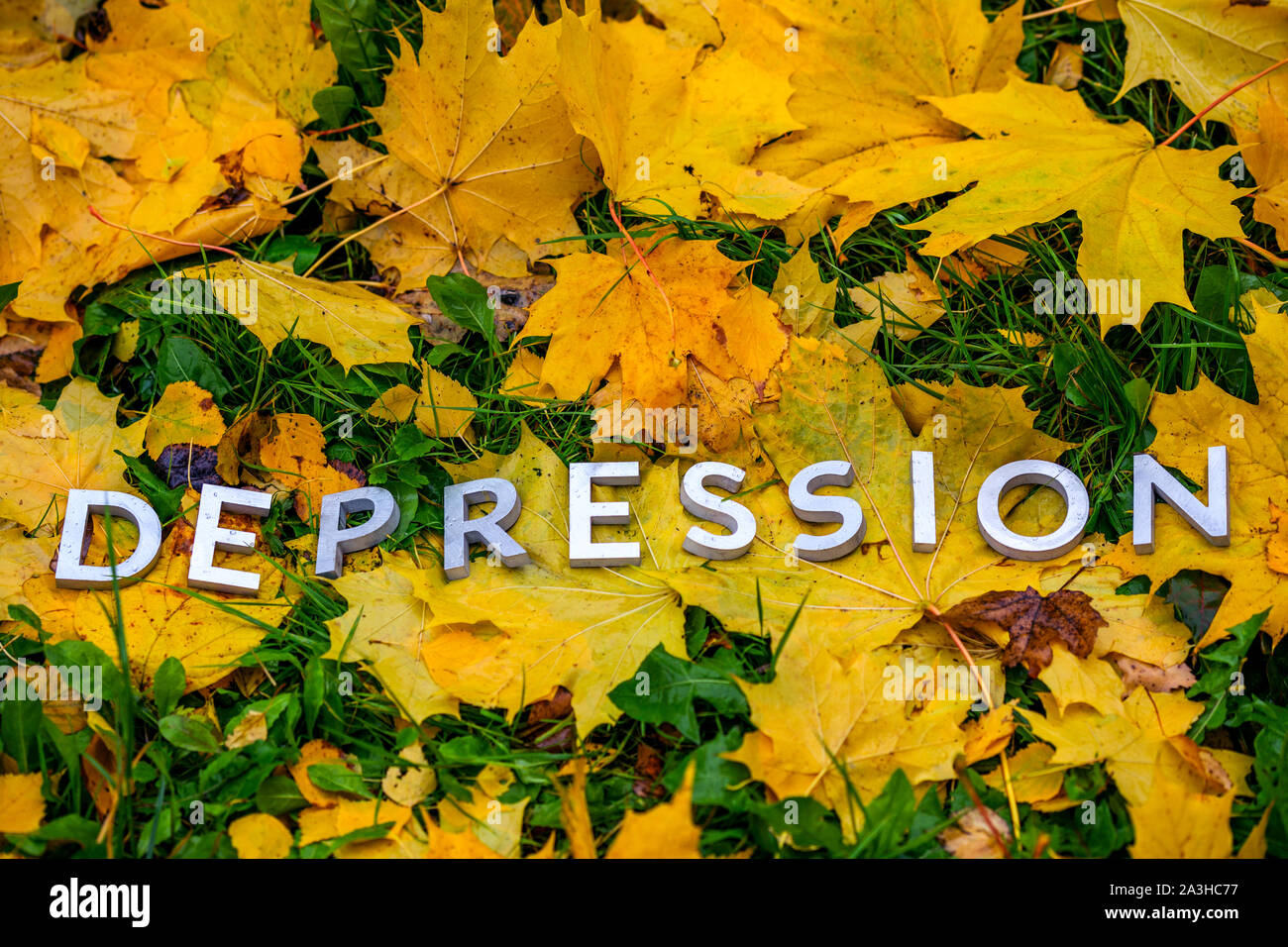 The word DEPRESSION laid with aluminium thick letters on the ground ...