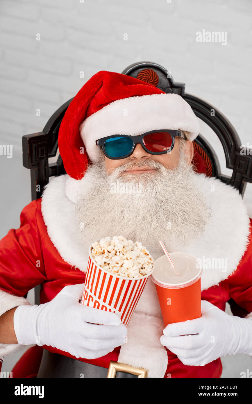 Authentic Santa Claus in 3d glasses snoozing in comfortable armchair ...
