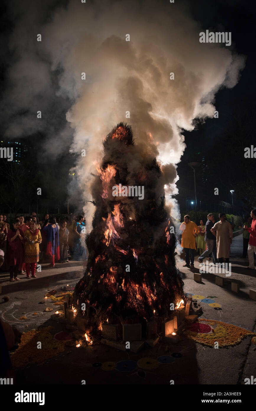 Smoke rises from a Holi bonfire at a housing complex in Mumbai, India ...