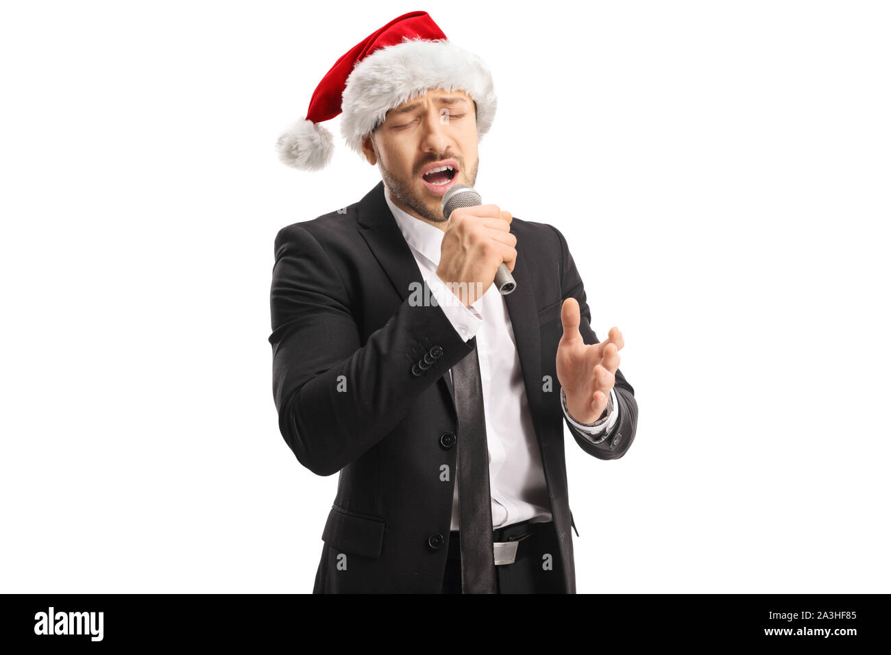 Man with a christmas hat singing on a microphone isolated on white ...