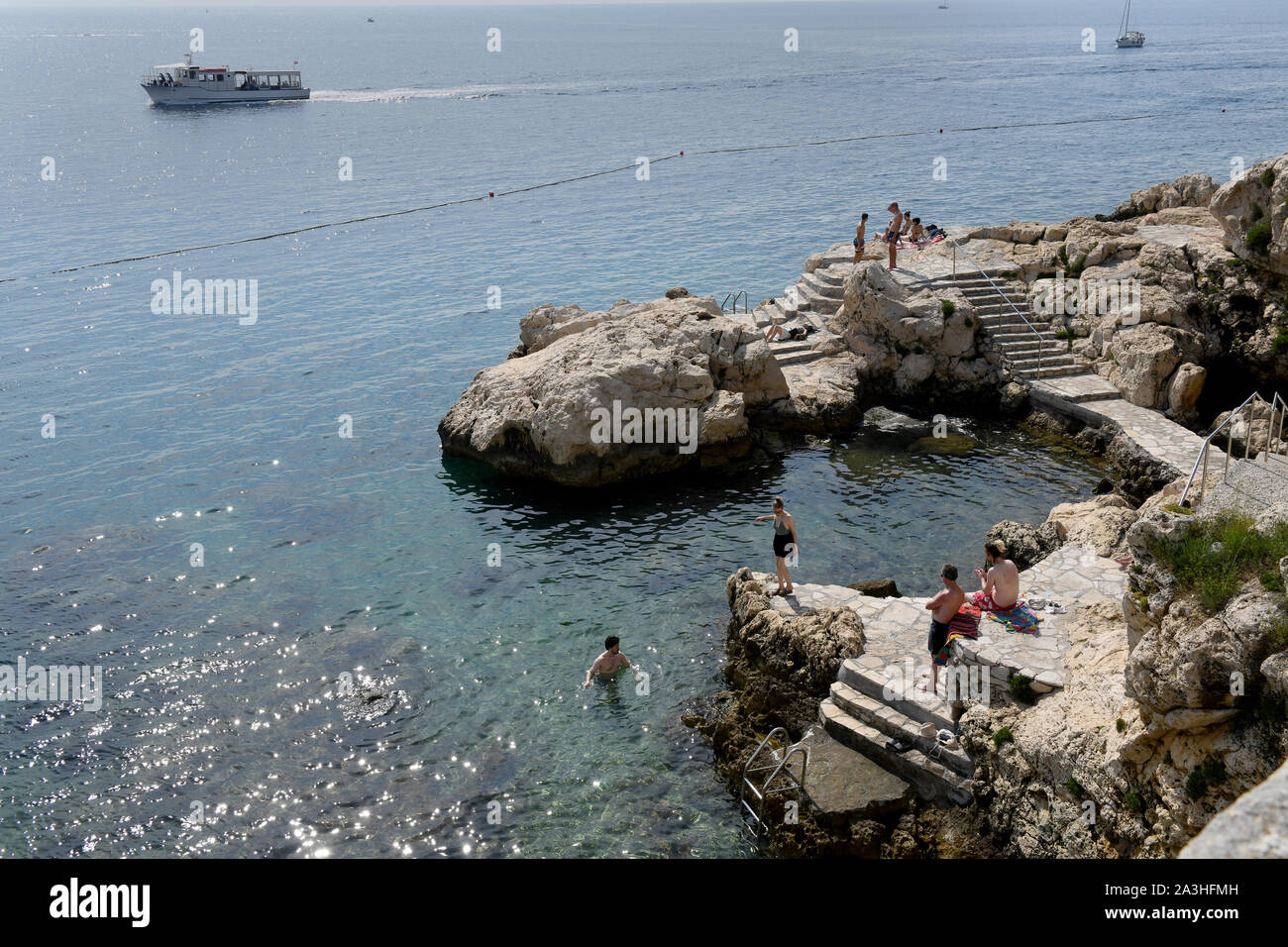Rovinj, Croatia tourists bathing and sunbathing on rocks Stock Photo ...