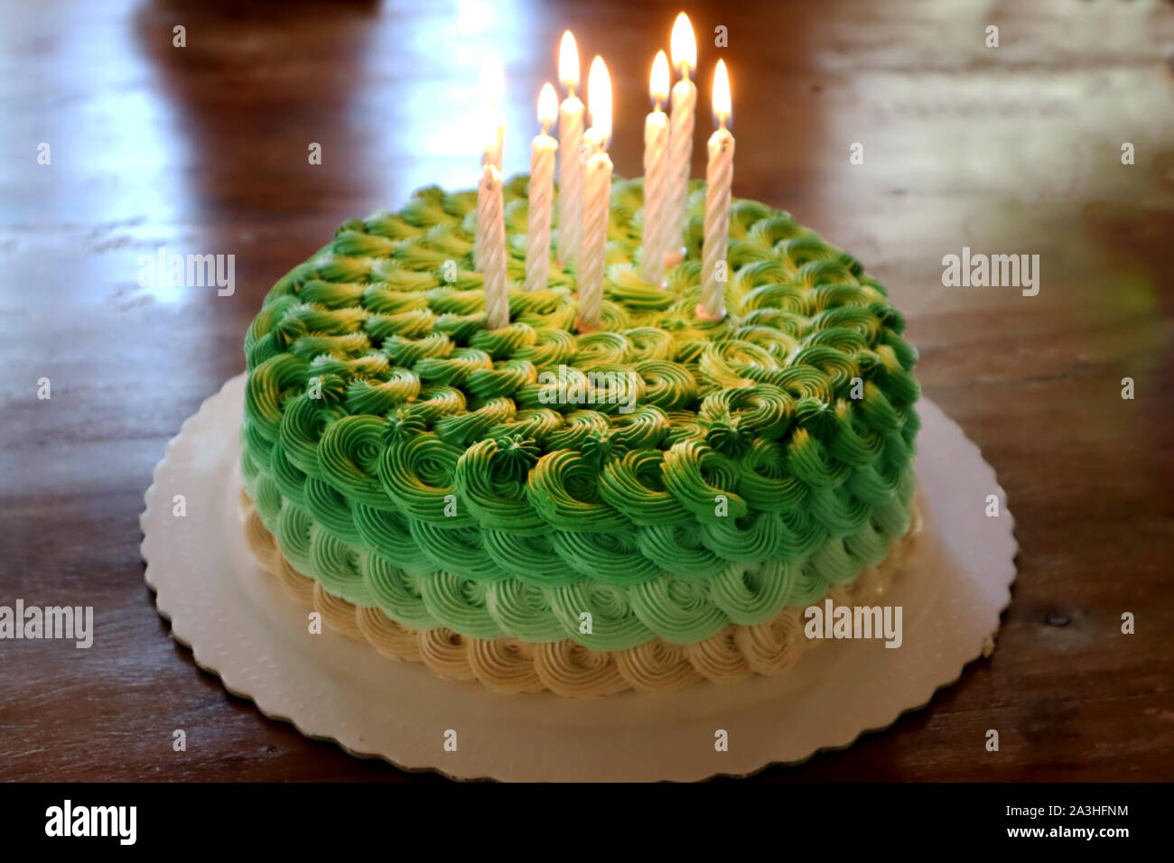 Birthday cake with candles. Green decoration on party anniversary cake ...