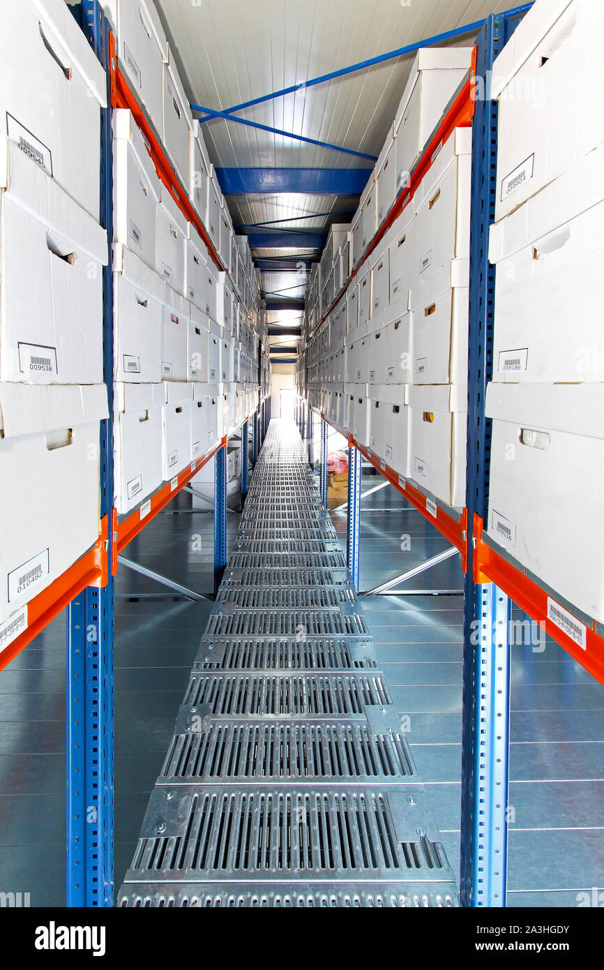 Long corridor of white boxes in warehouse Stock Photo - Alamy