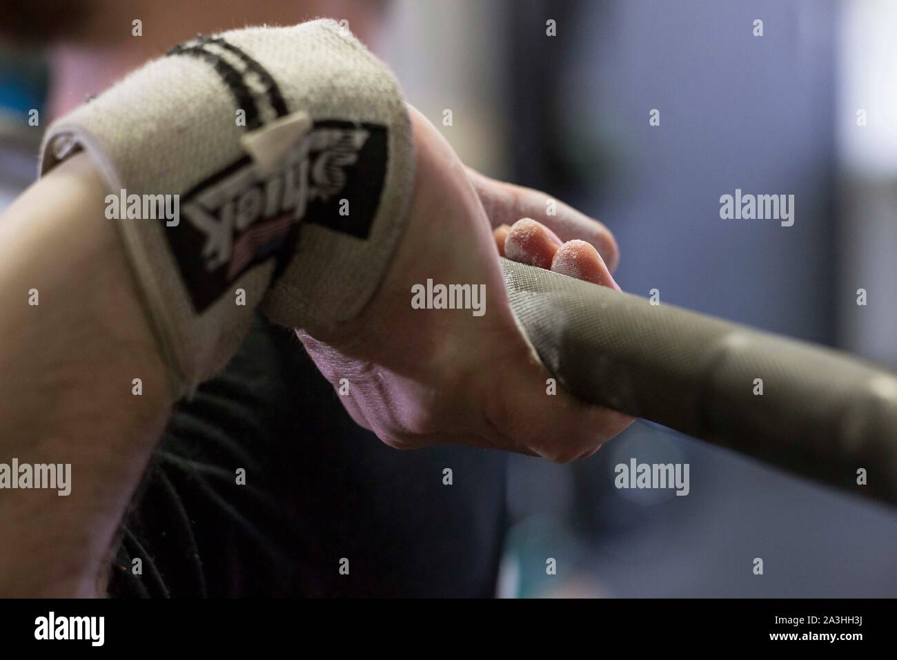 A young white male athlete performs various lifts and bodyweight ...
